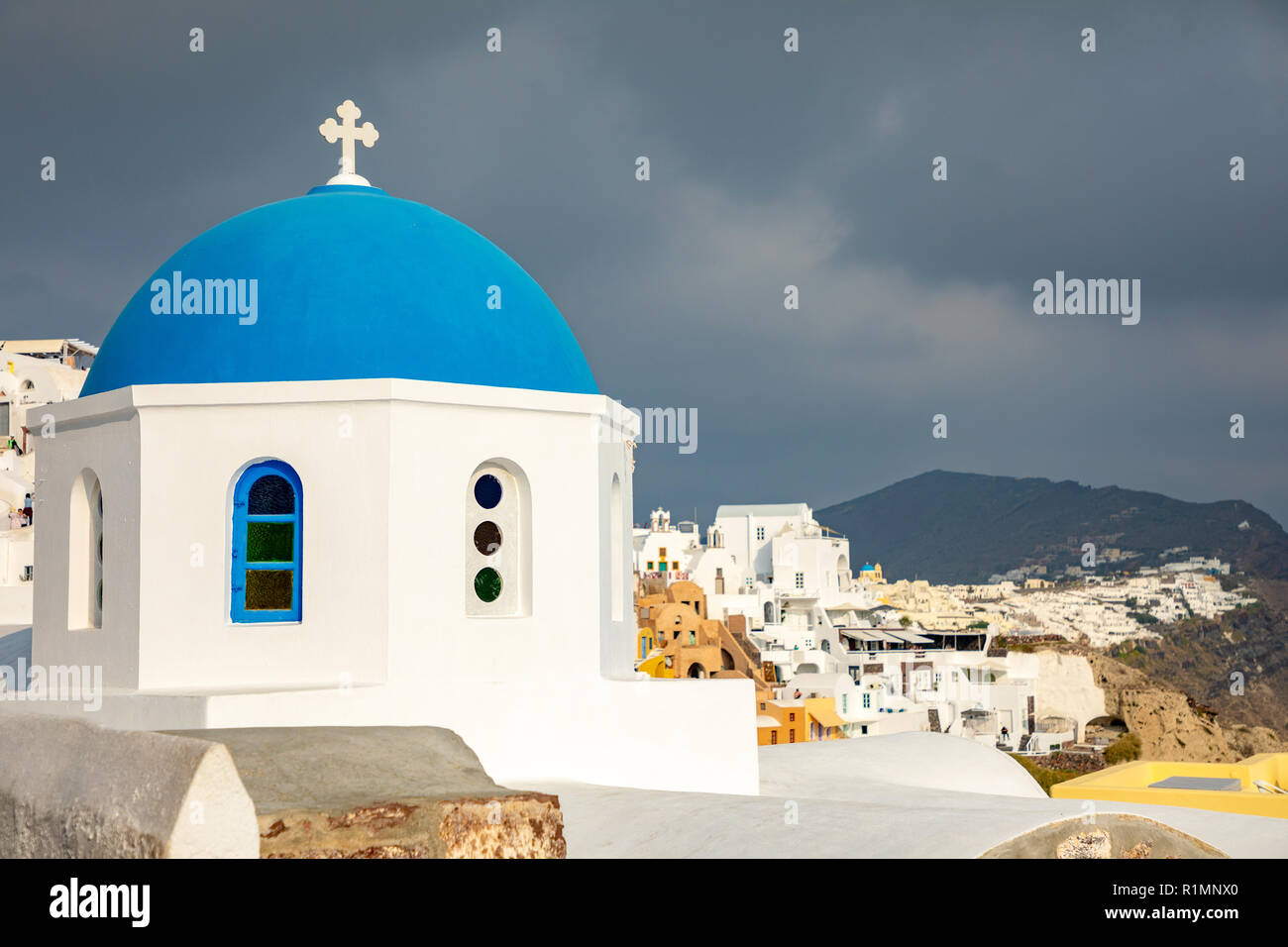 Traditional and famous houses and churches with blue domes in Oia ...