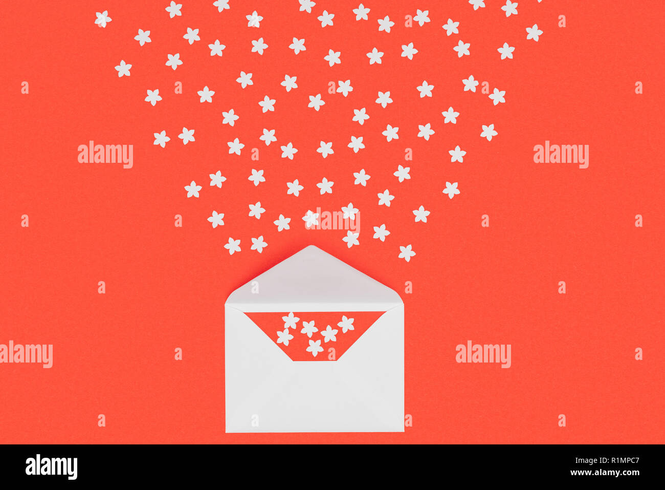 close-up view of white envelope with red card and small white stars ...
