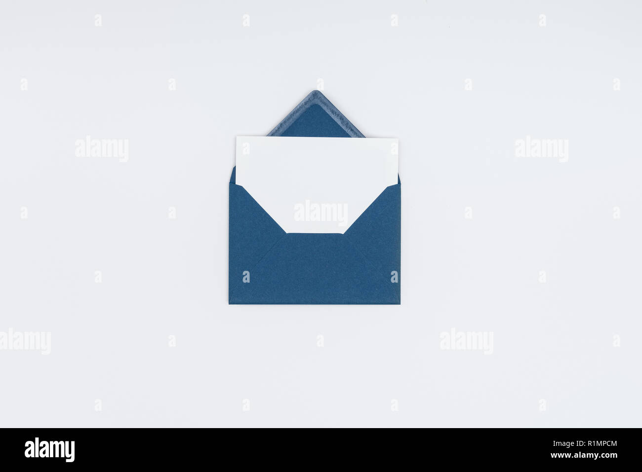 close-up view of blue open envelope with blank white card isolated on ...