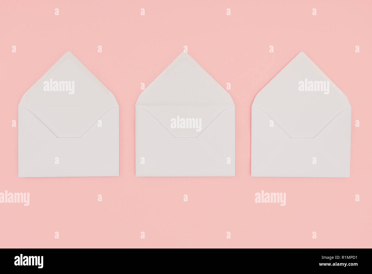 top view of open white envelopes isolated on pink Stock Photo - Alamy