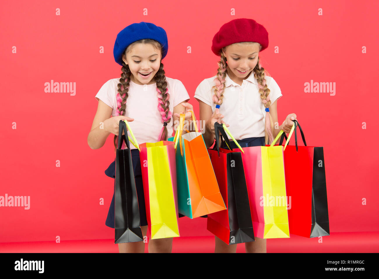 Kids cute schoolgirls hold bunch shopping bags. Children satisfied by ...