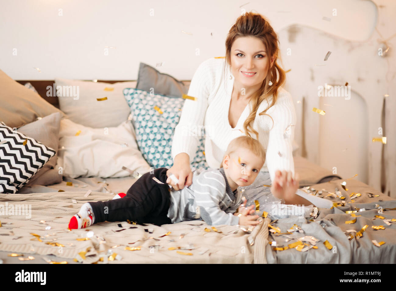 Lovely mother rising up her baby and smiling to each other Stock Photo ...