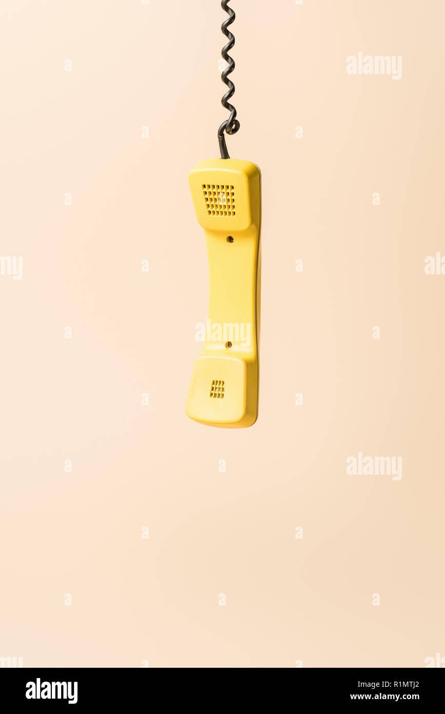 yellow vintage phone tube on beige Stock Photo - Alamy