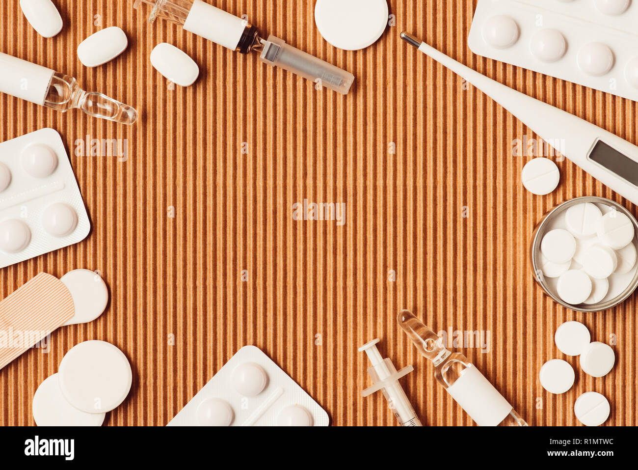 top view of various medical instruments and drugs on cardboard ...
