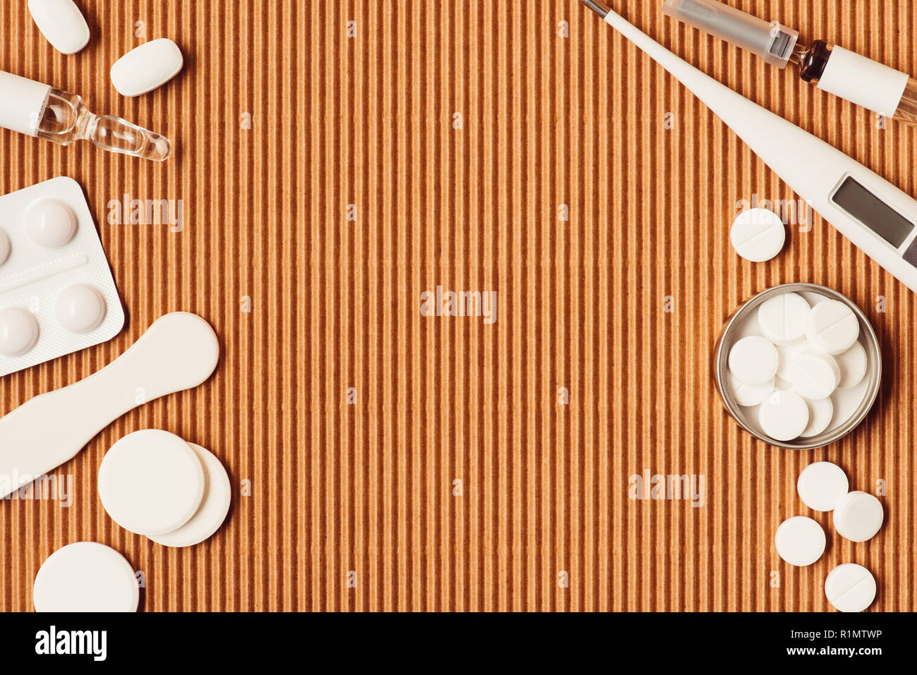 flat lay of various medical tools and medicines on cardboard background ...