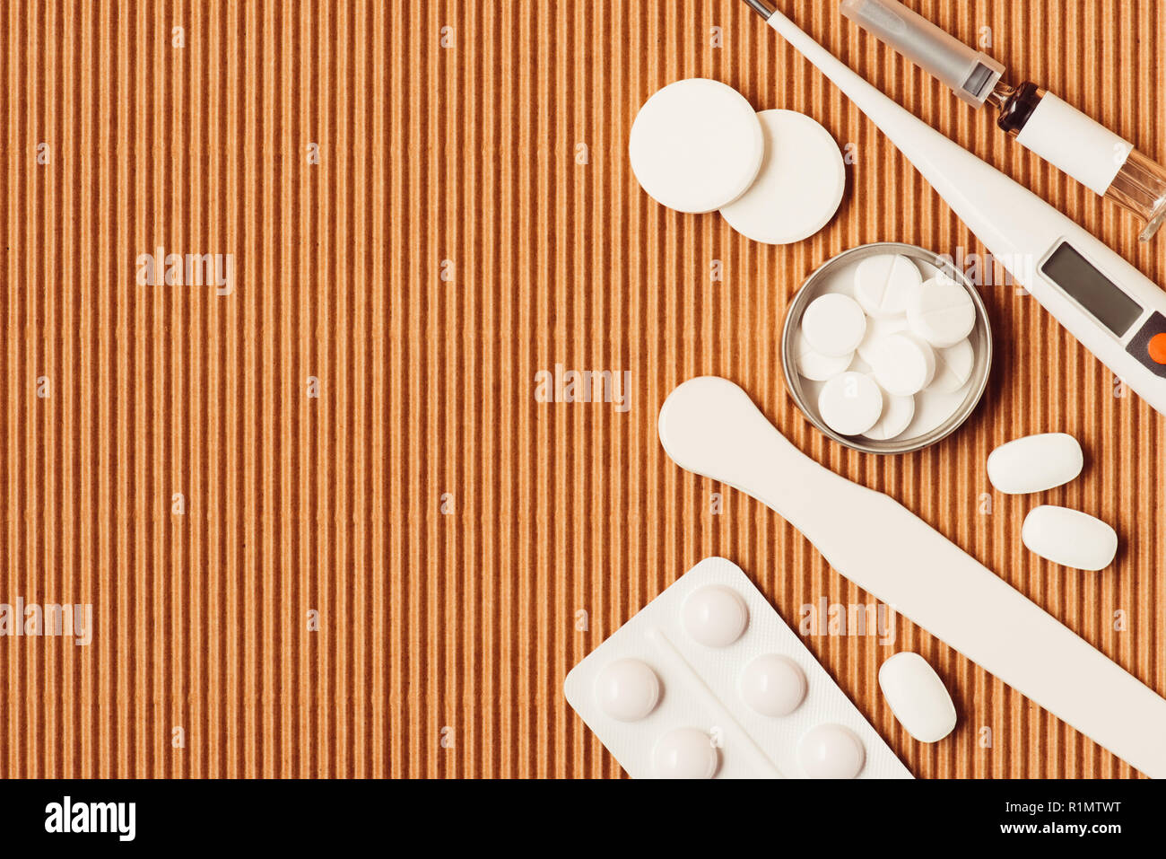 top view of various medical tools and drugs on cardboard background ...