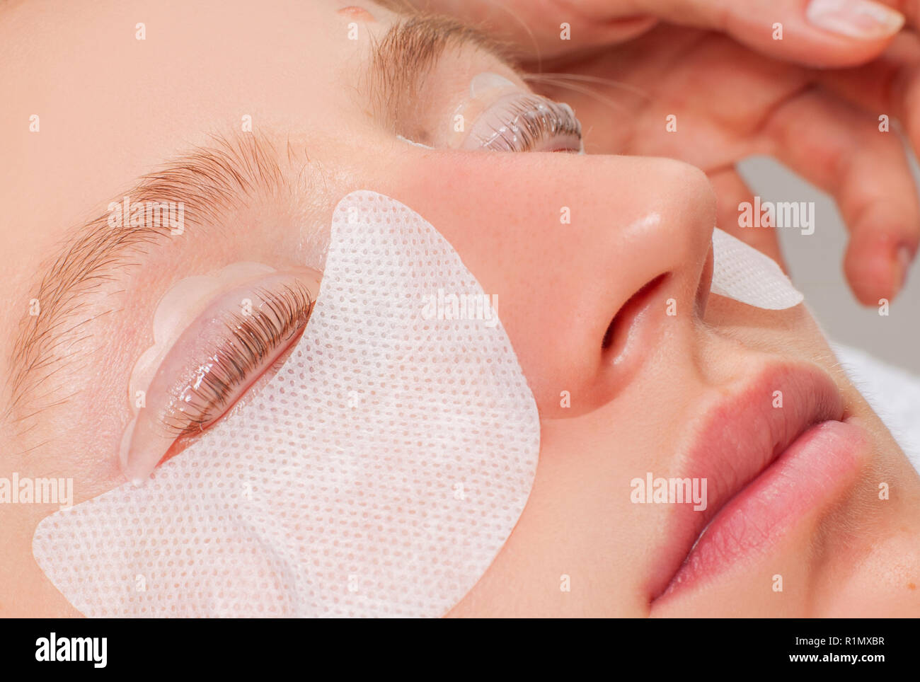 Eyelash care treatment procedures. Woman doing eyelashes lamination ...