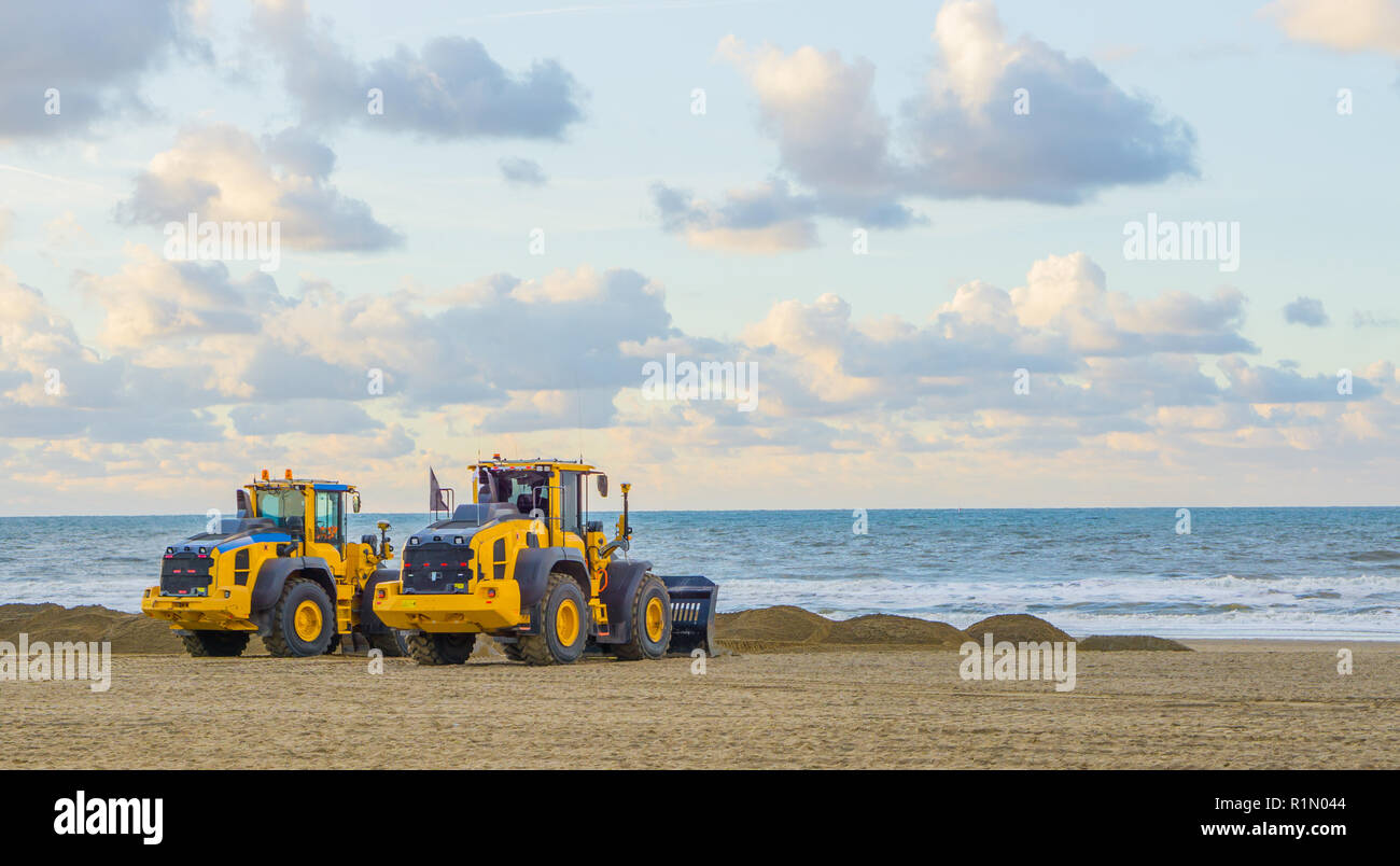 earthmoving equipment machines working at the beach for maintenance ...