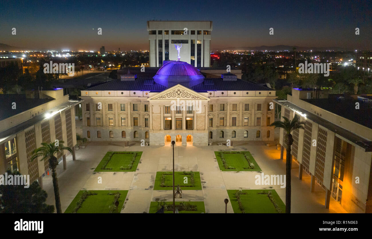 Blue light illuminates the roof of the Arizona Capitol building in ...