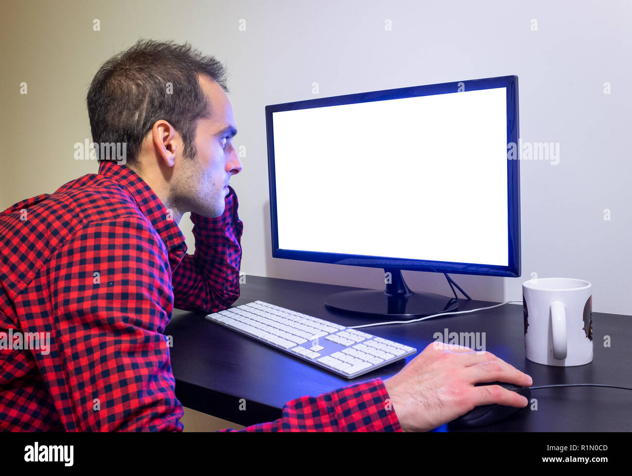 Sad young man stares computer hi-res stock photography and images - Alamy