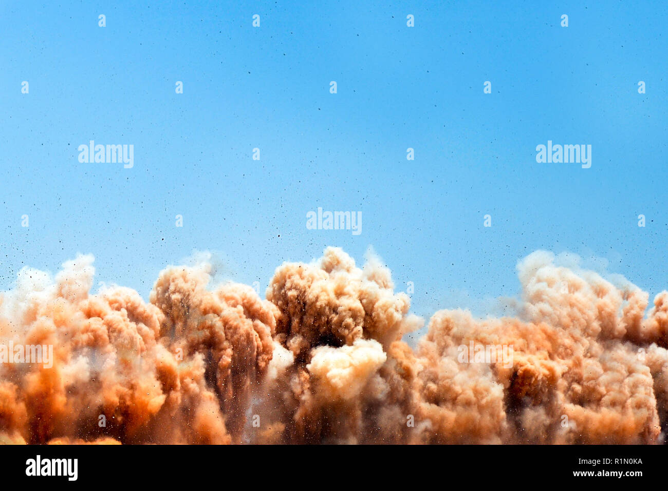 Flying rocks and dust clouds after the blast in on the construction ...
