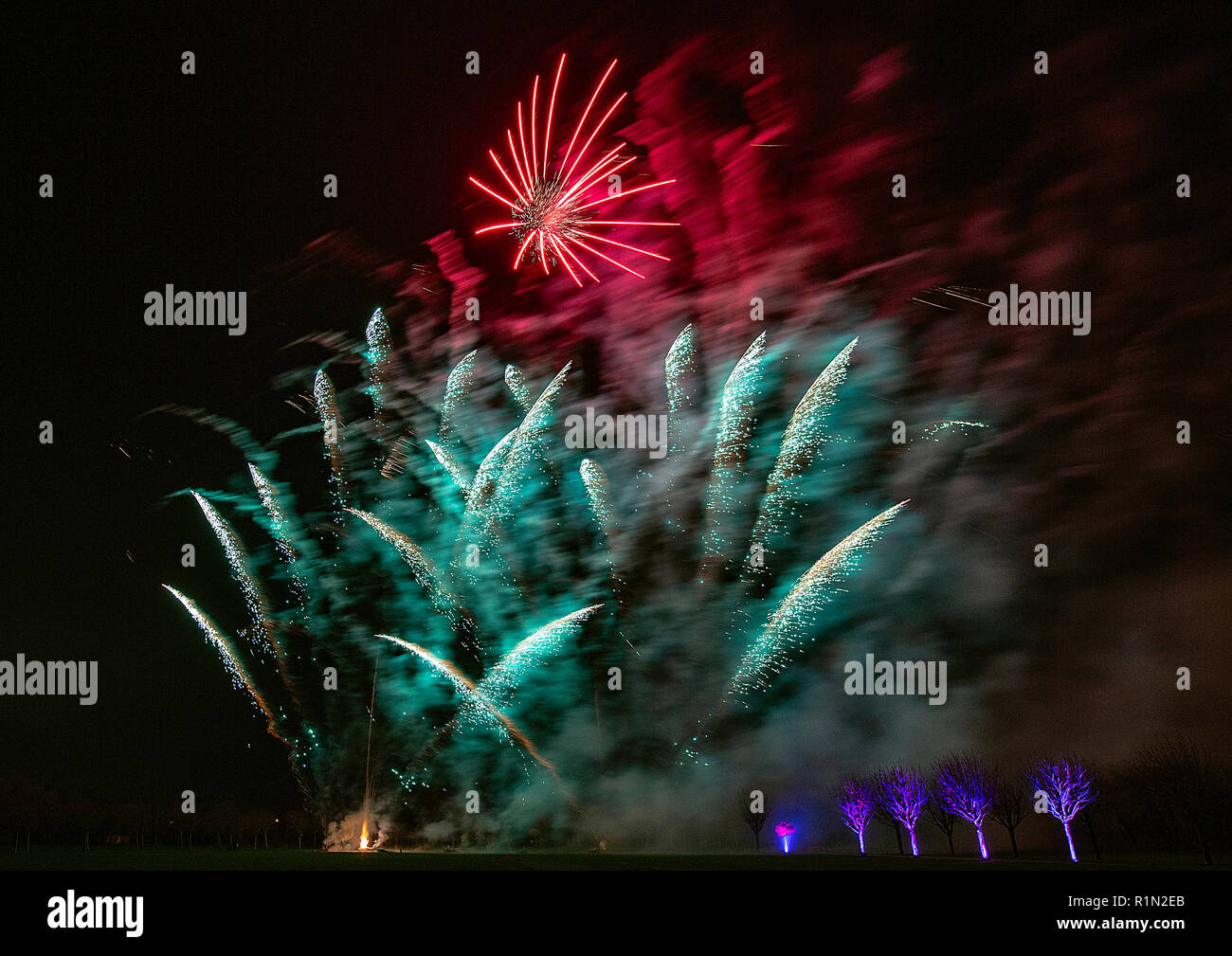 Spectacular and colourful firework display set against a dark Autumn ...