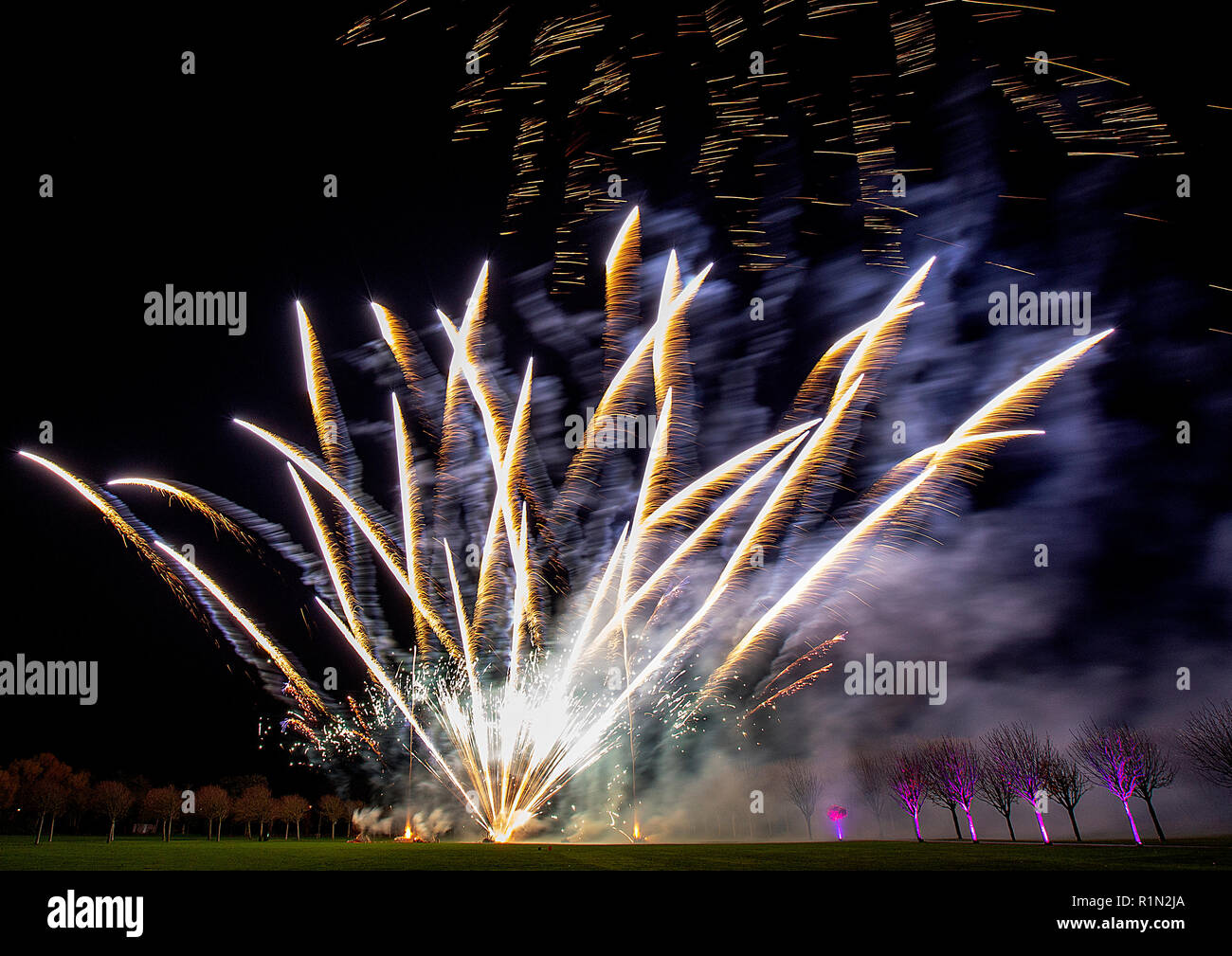 Spectacular and colourful firework display set against a dark Autumn ...