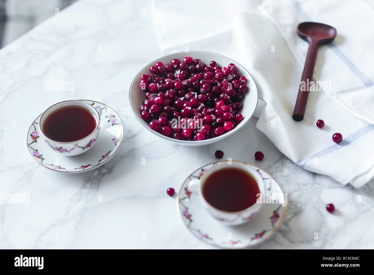 cranberry cowberry on marble background with tea Stock Photo - Alamy