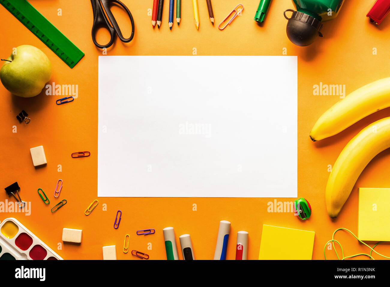 orange bright desk table with school accessories with office supplies ...