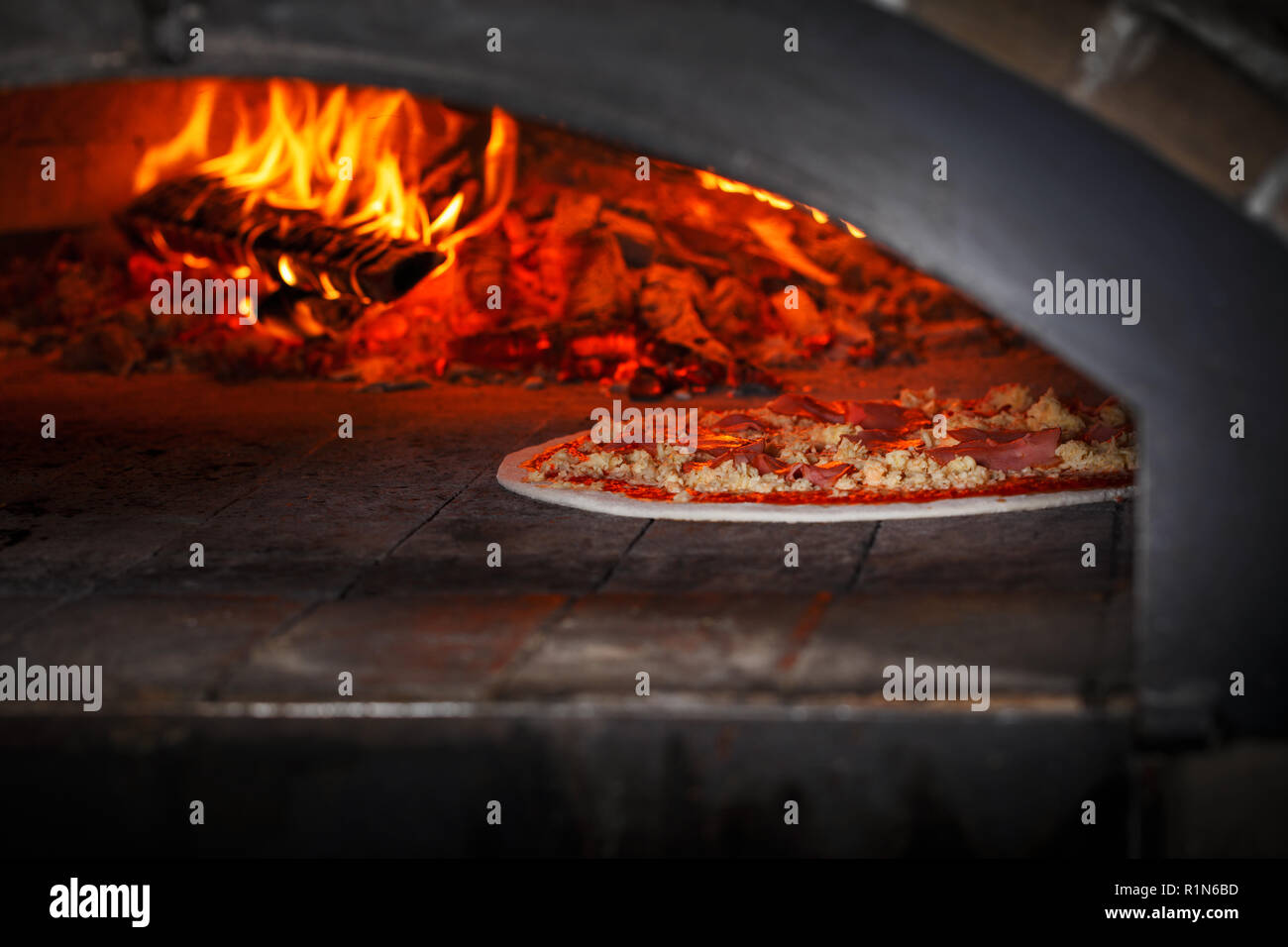 Pizza in the oven. Pizza with ham, Bulgarian pepper and cheese Stock ...