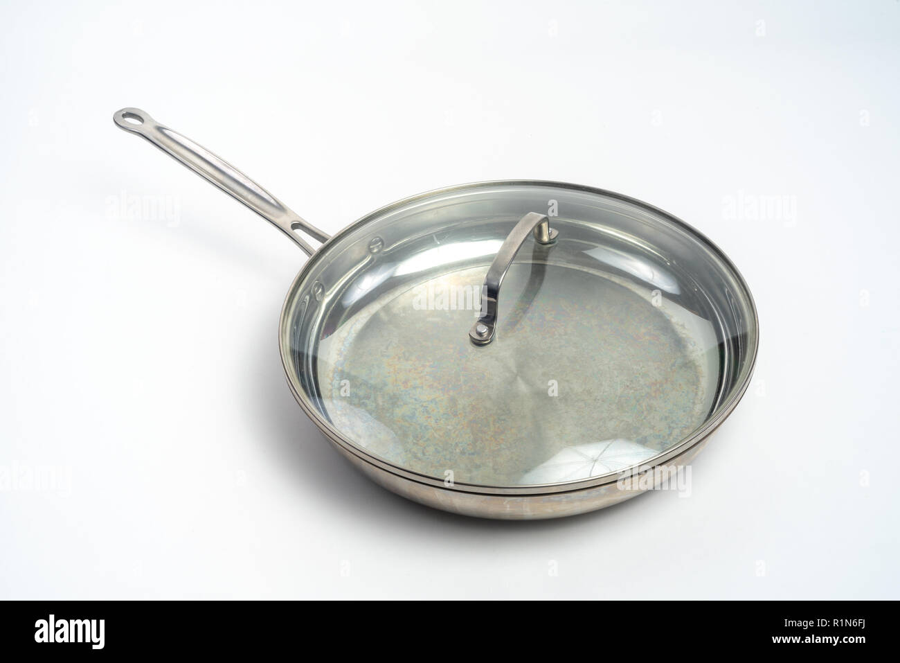 Large metal frying pan, isolated steel with handle and glass lid Stock ...