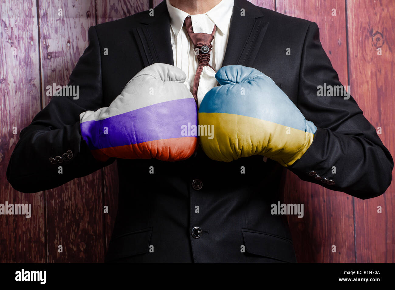 Businessman in boxing gloves with Russian and Ukraine flag. Russia ...