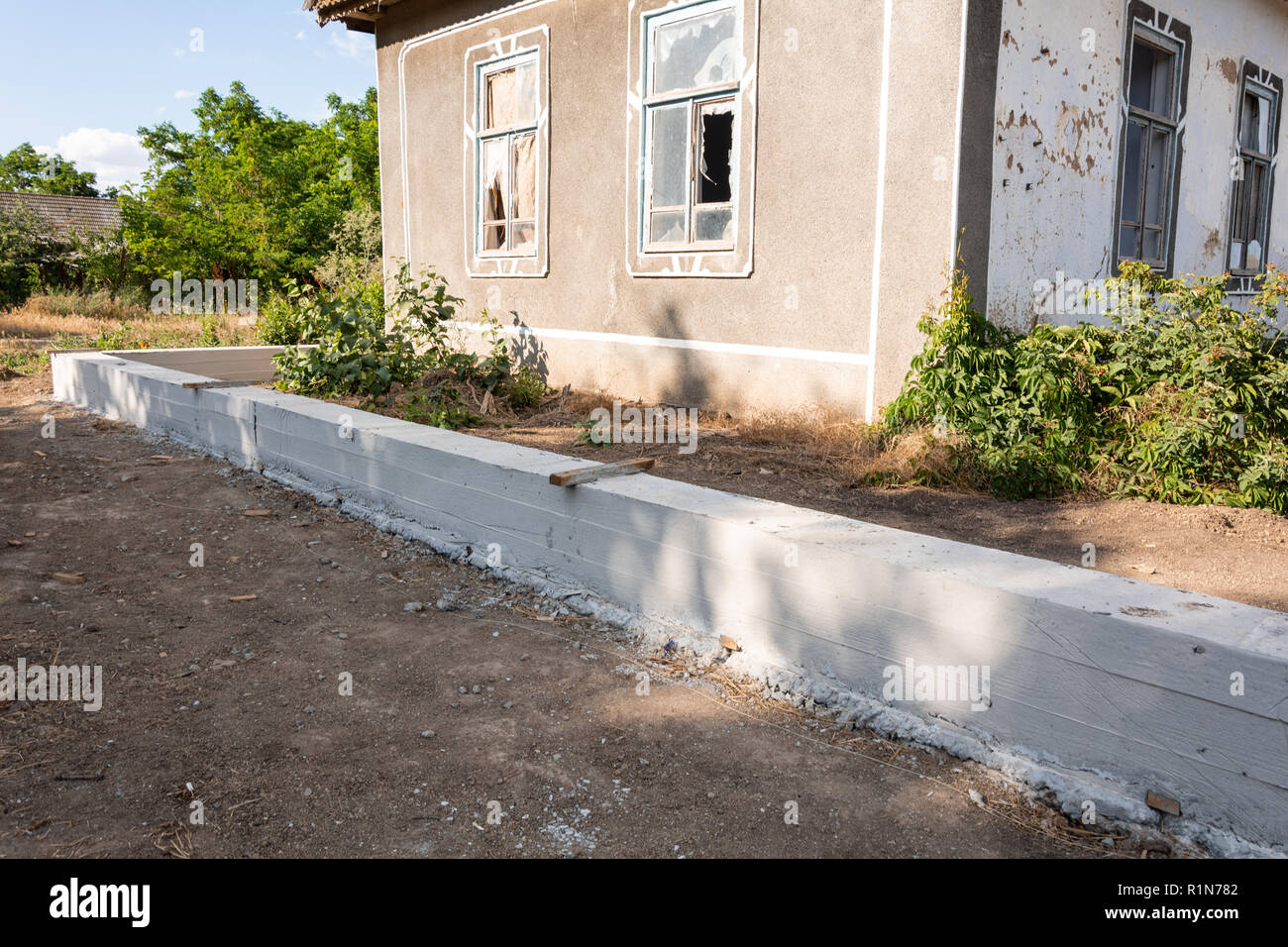 Building concrete foundation for wooden rural fence. Foundation for ...