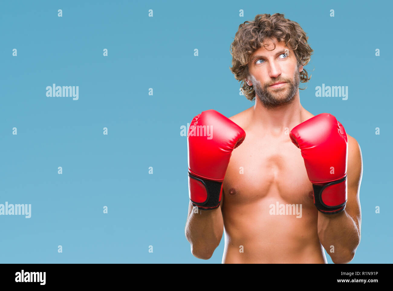 Handsome hispanic boxer man wearing boxing gloves over isolated ...