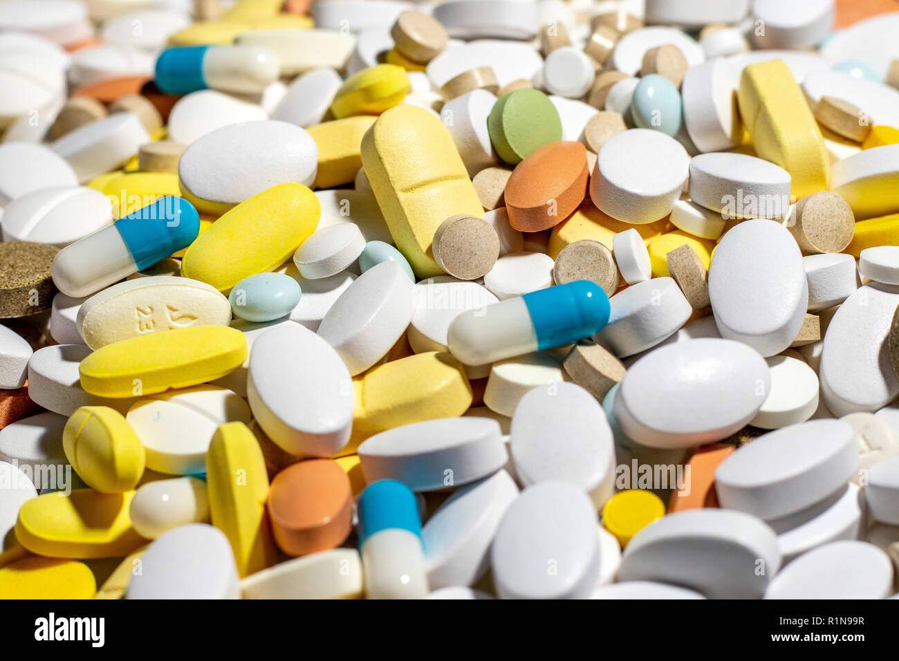 multi-colored pills and drugs close-up, treatment of diseases drugs ...