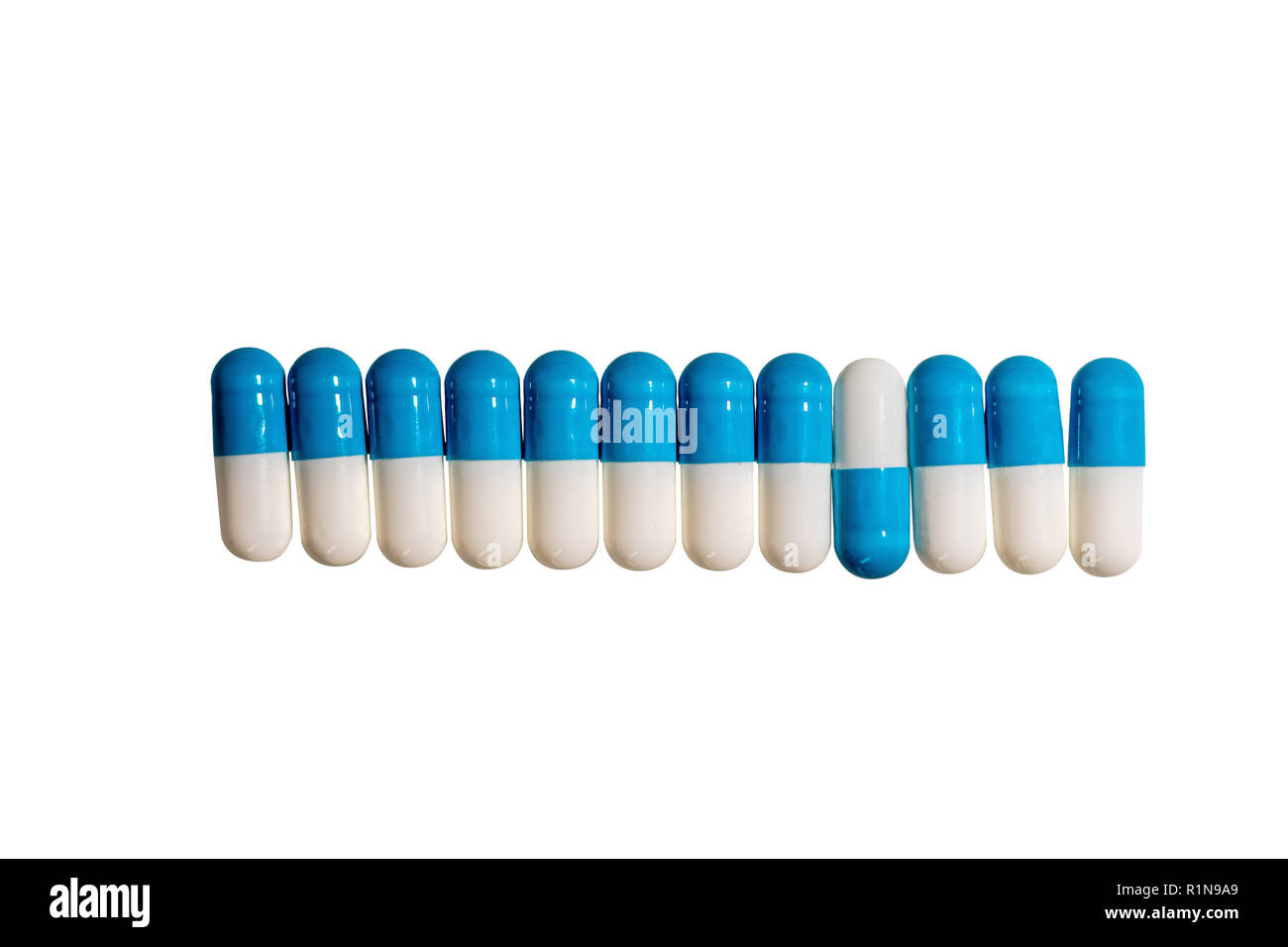 white and blue pill for treating disease on white background isolated ...