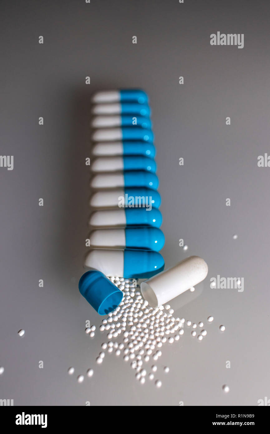 white and blue pill for treating disease on white background Stock ...