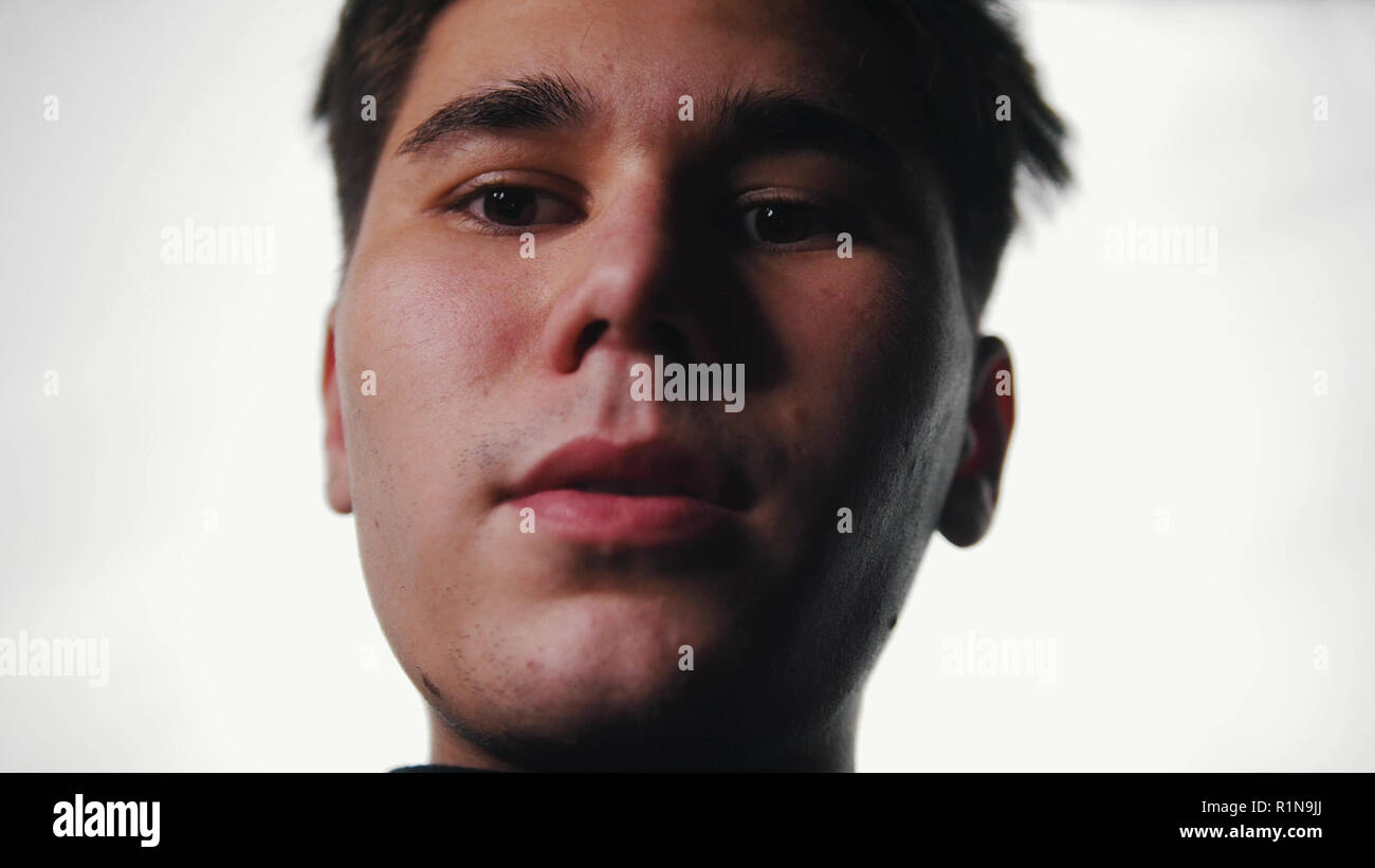 A man looking down in the camera. Bright light Stock Photo - Alamy