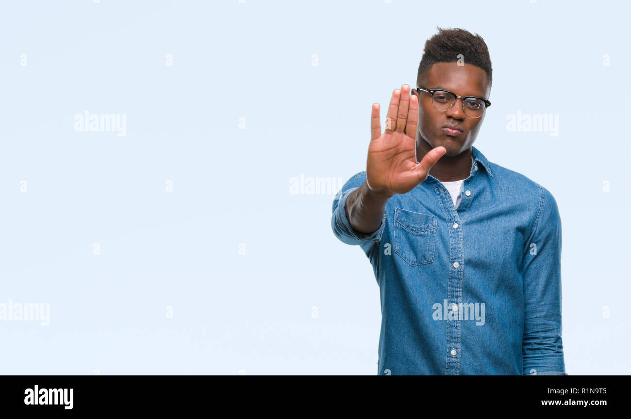 Young african american man over isolated background doing stop sing ...