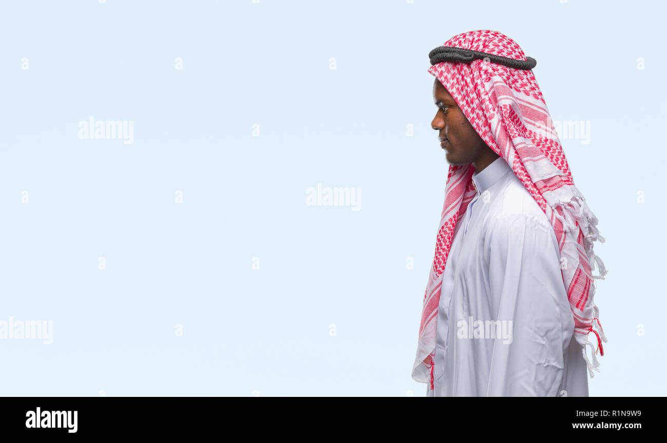 Young arabic african man wearing traditional keffiyeh over isolated ...