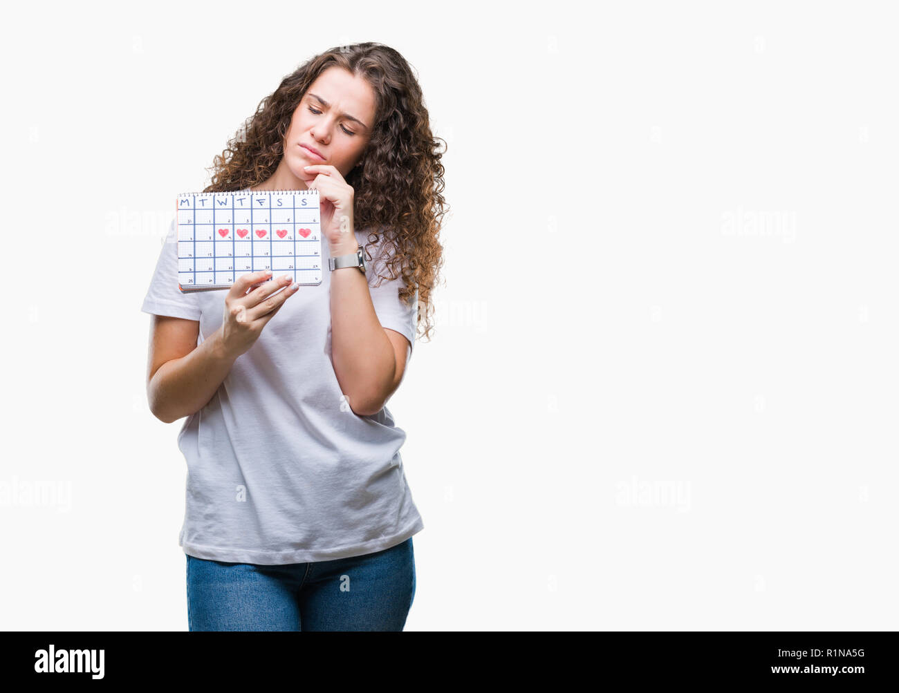 Young brunette girl holding menstruation calendar over isolated ...