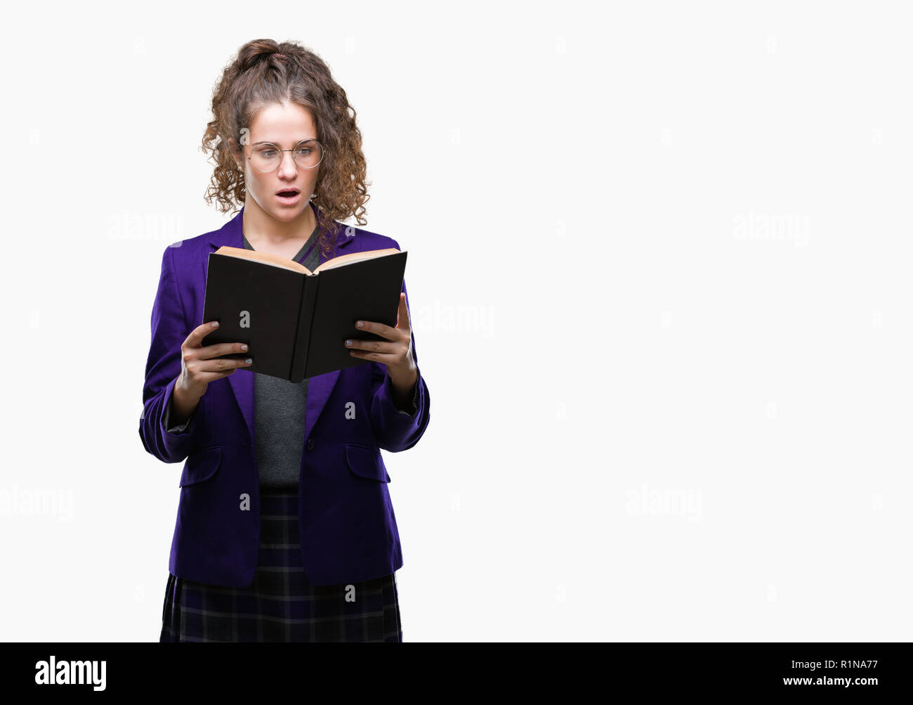 Young brunette student girl wearing school uniform reading a book over ...