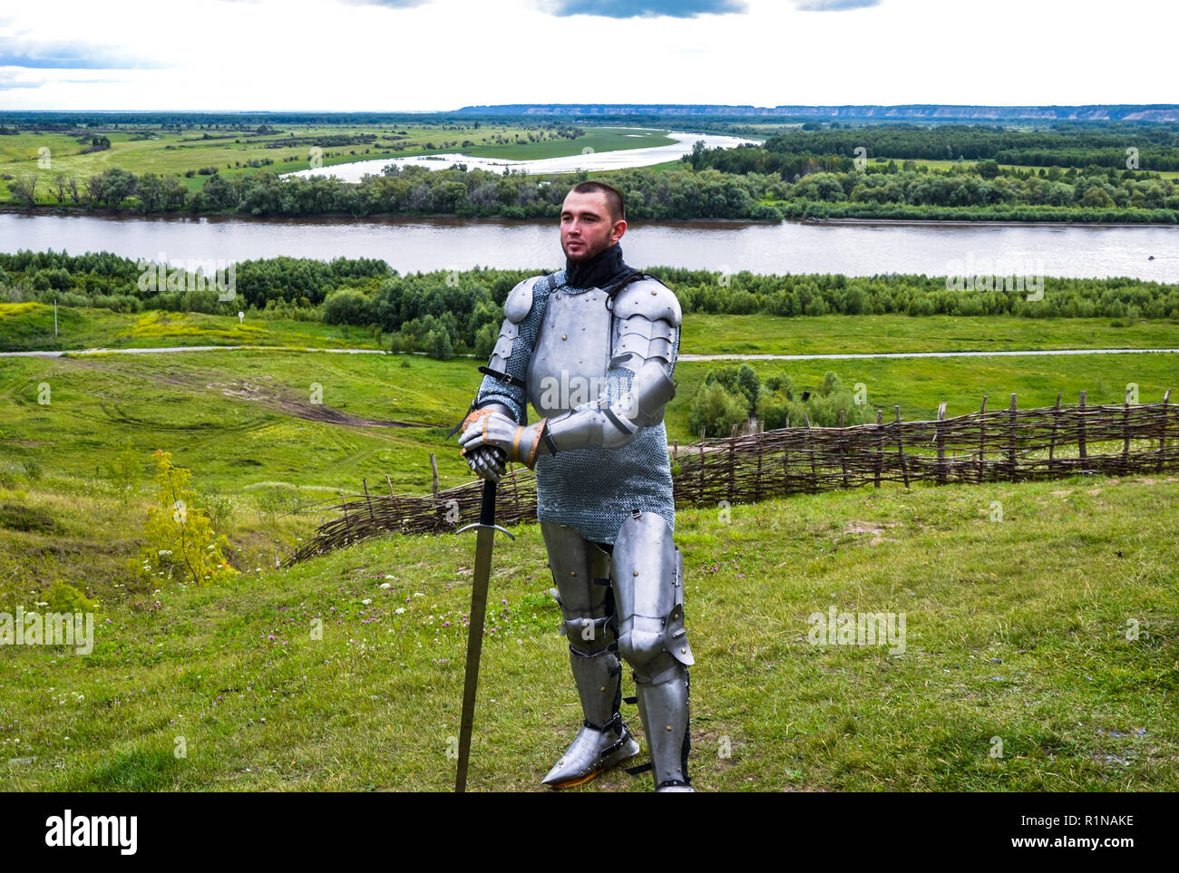 knight in armor stands against the background of native open spaces ...