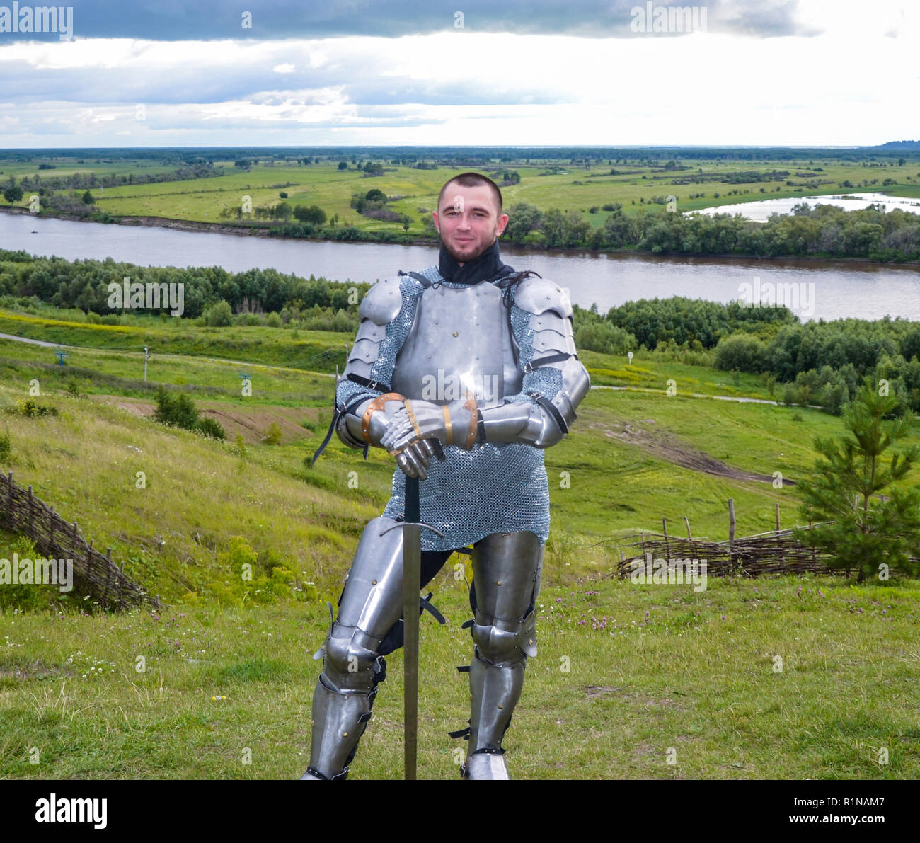 knight in armor stands against the background of native open spaces ...