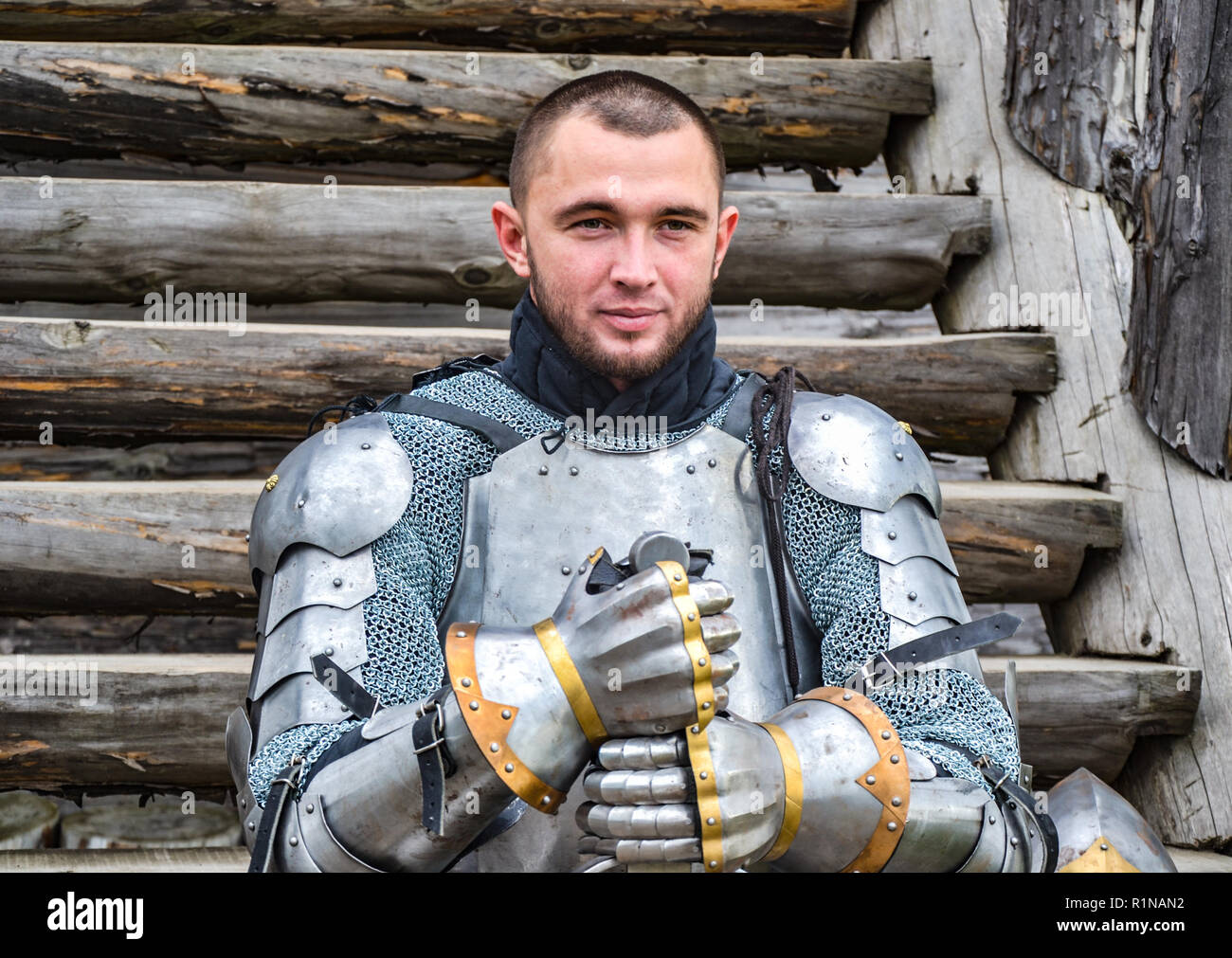 Knight in the armor on the wooden steps. Knightly armor and weapon ...