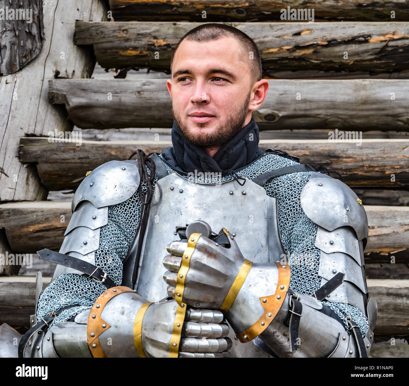 Knight in the armor on the wooden steps. Knightly armor and weapon ...