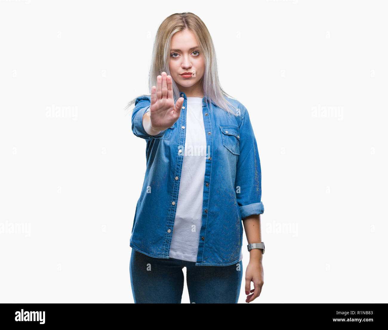 Young blonde woman over isolated background doing stop sing with palm ...