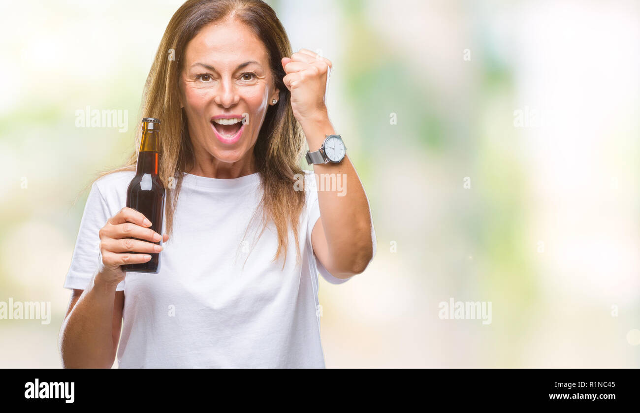 Middle age hispanic woman drinking beer over isolated background ...