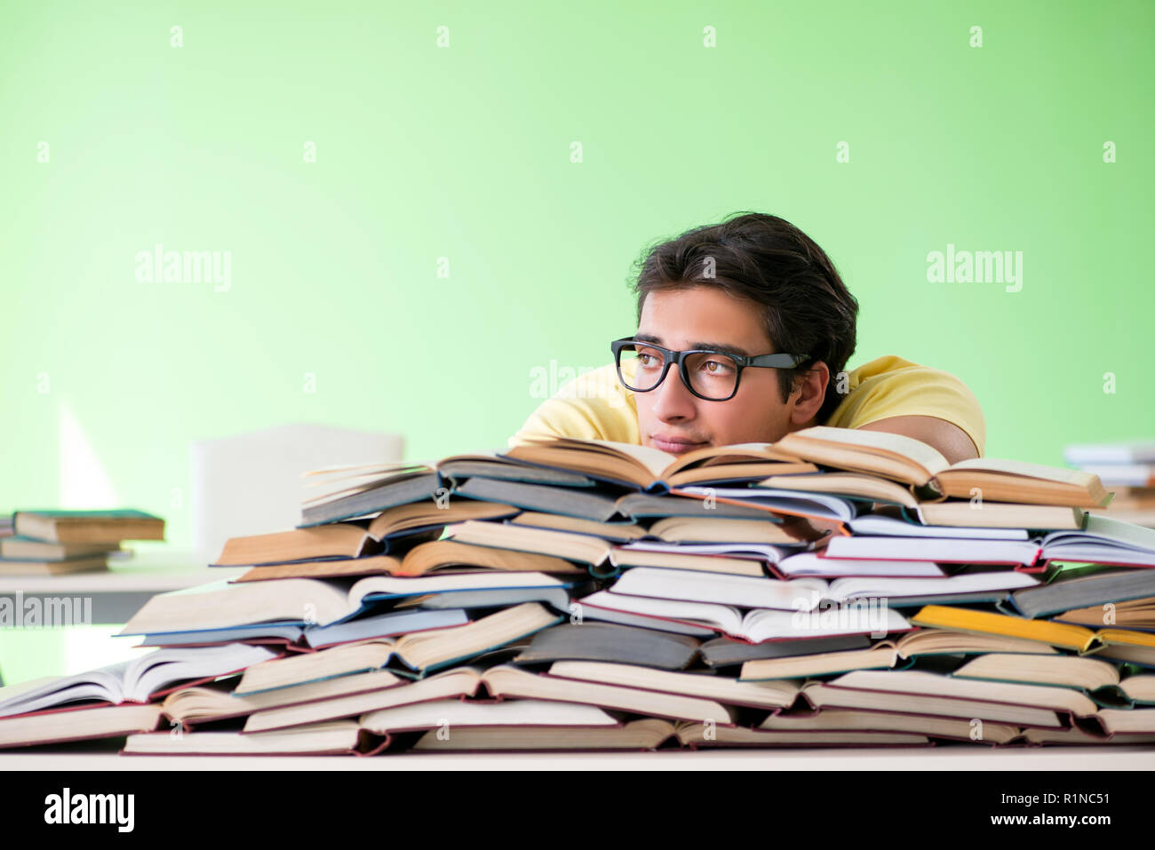 Student with too many books to read before exam Stock Photo - Alamy