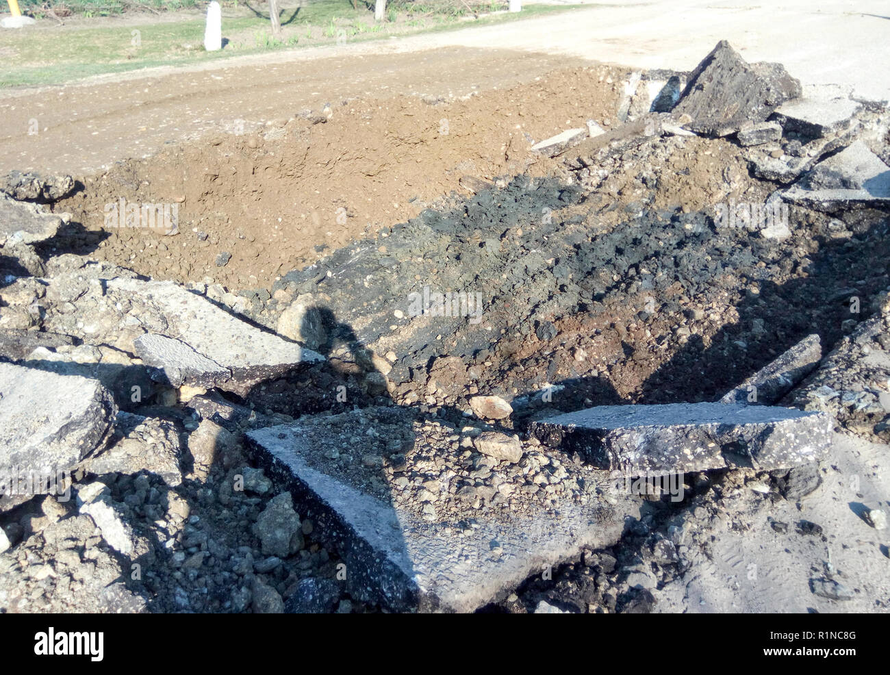 Pit on the road. Dug up the asphalt. Road repair Stock Photo - Alamy
