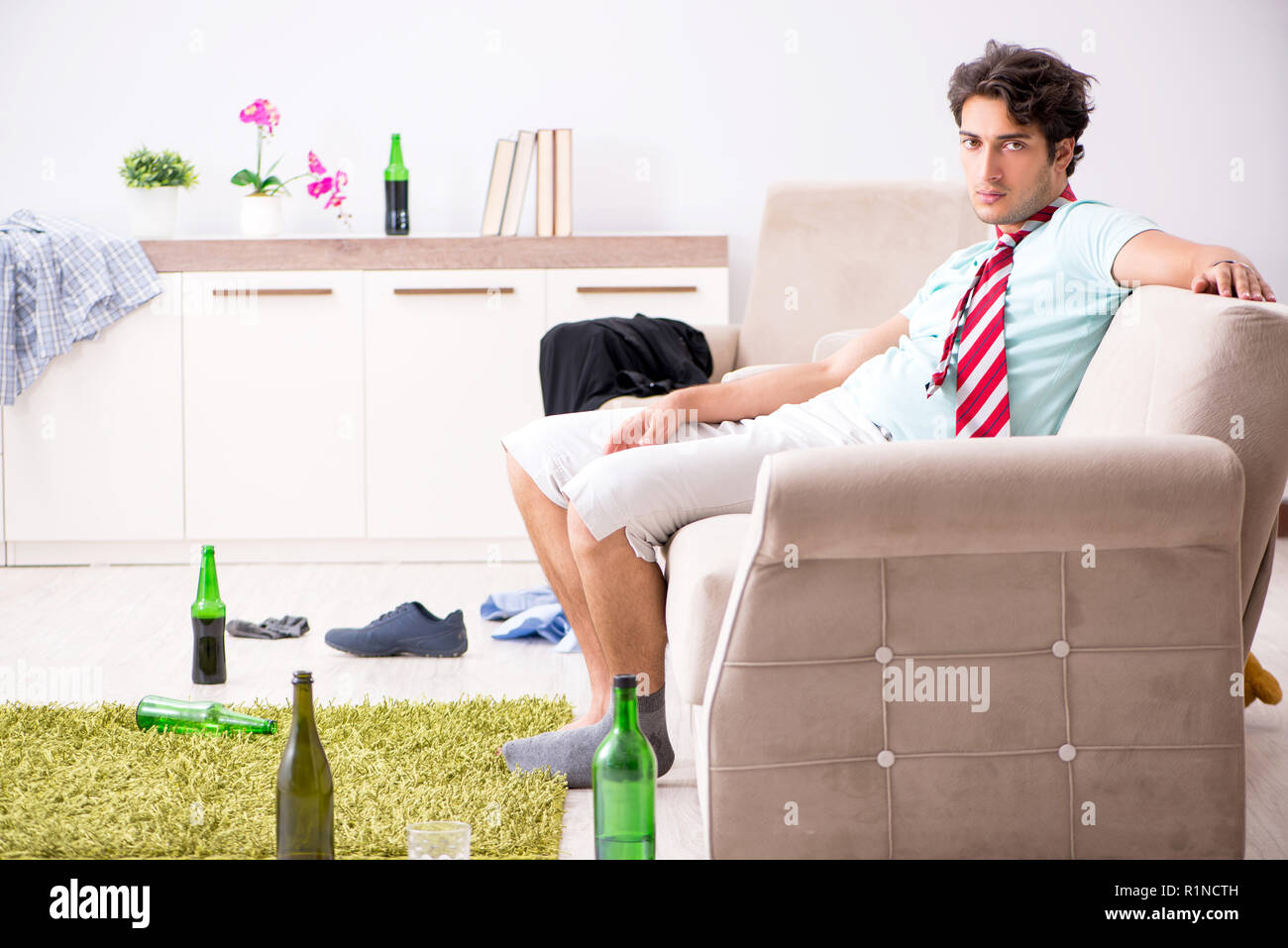 Young drunk handsome man after party at home Stock Photo - Alamy