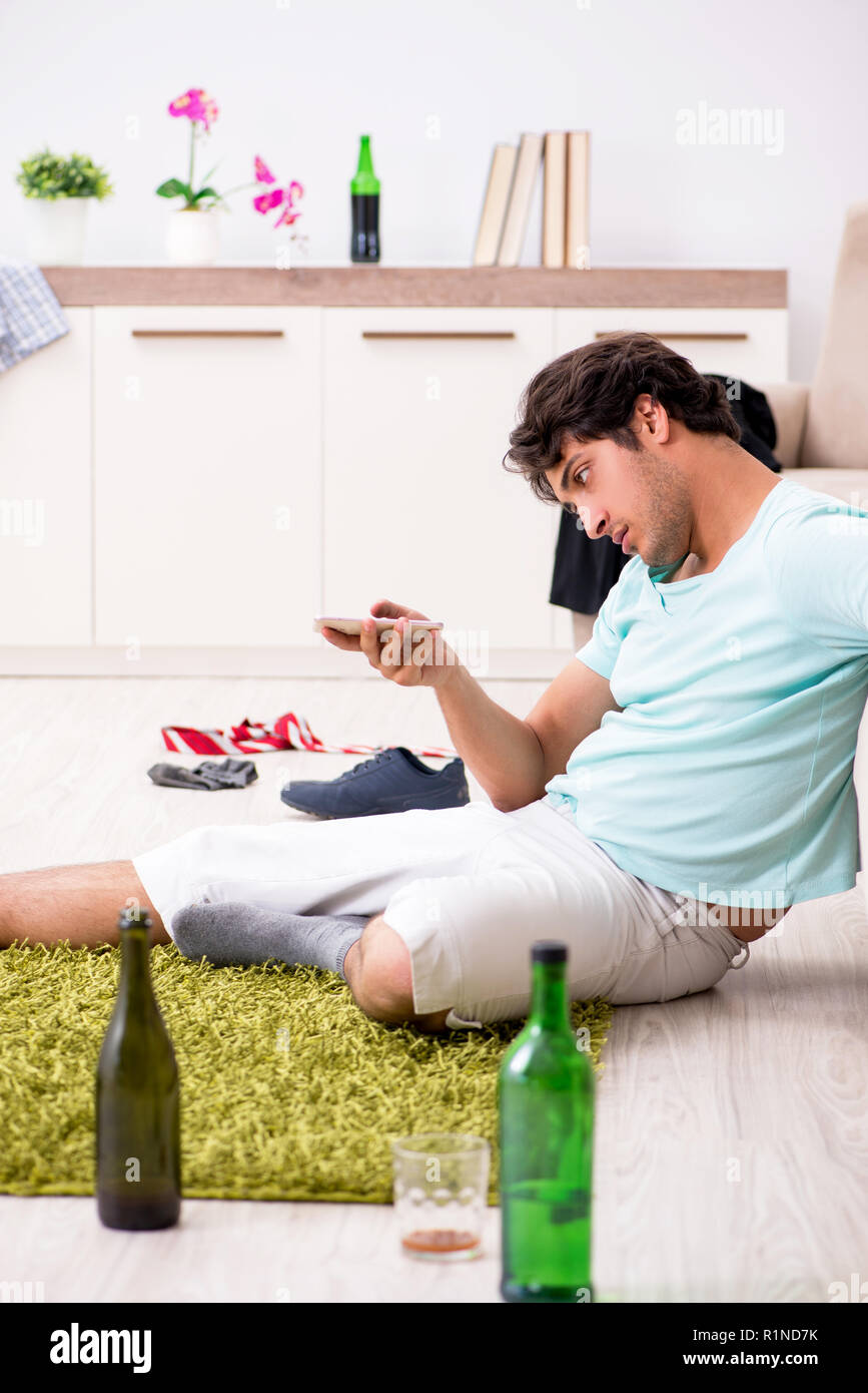 Young drunk handsome man after party at home Stock Photo - Alamy
