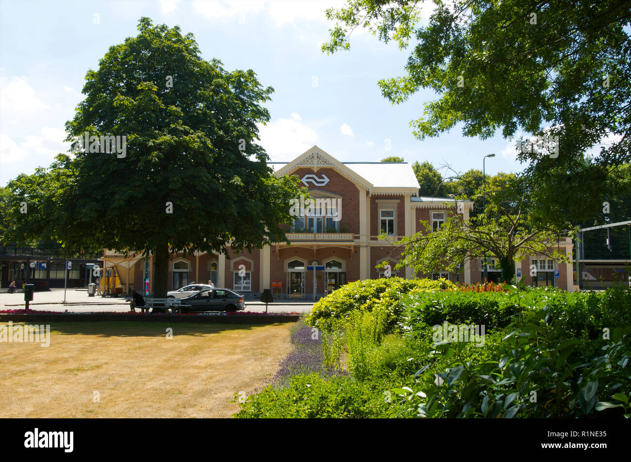 The front side of the historic railway station with a small park used ...