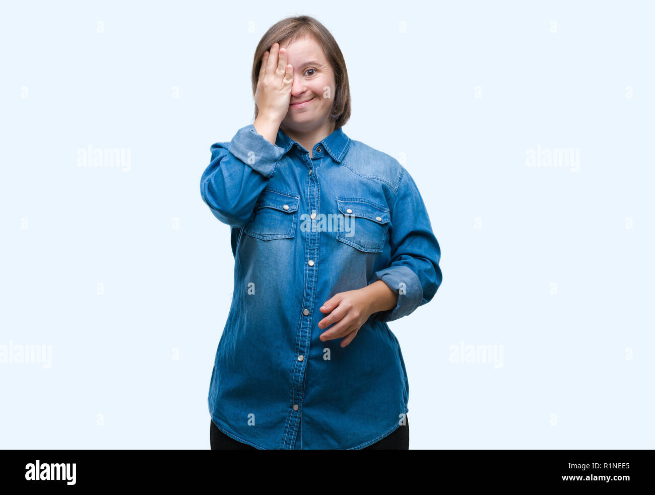 Young adult woman with down syndrome over isolated background covering ...