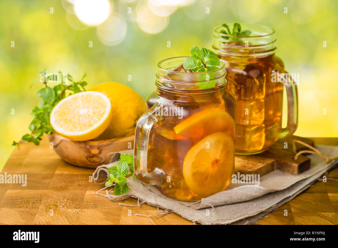 Iced tea in glass jars, in the garden Stock Photo - Alamy