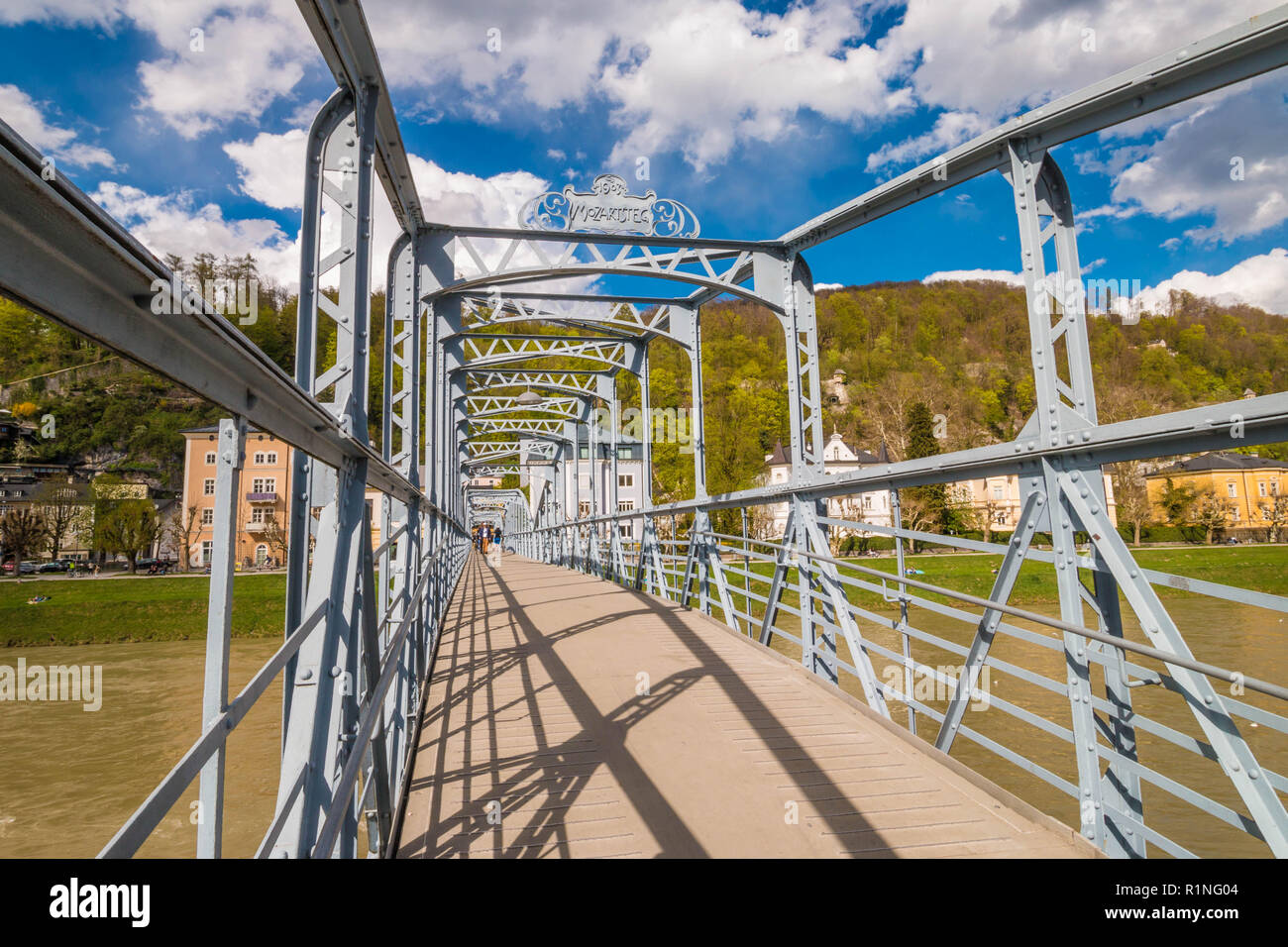 Pedestrian walking Art nouveau Mozart bridge (Mozartsteg) across ...