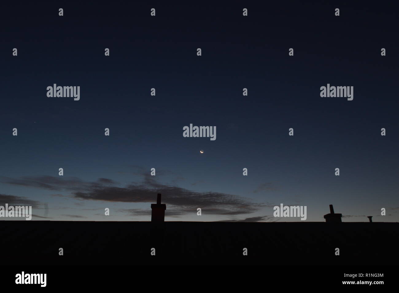 moon over a roof on early morning Stock Photo - Alamy