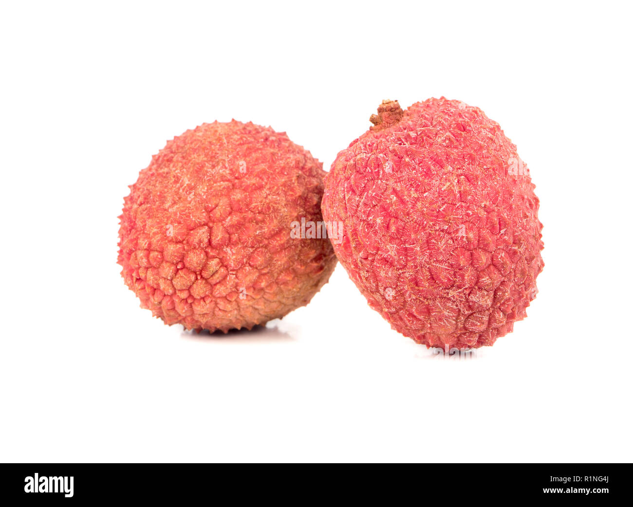Two lychee fruit in shell isolated on white background Stock Photo - Alamy