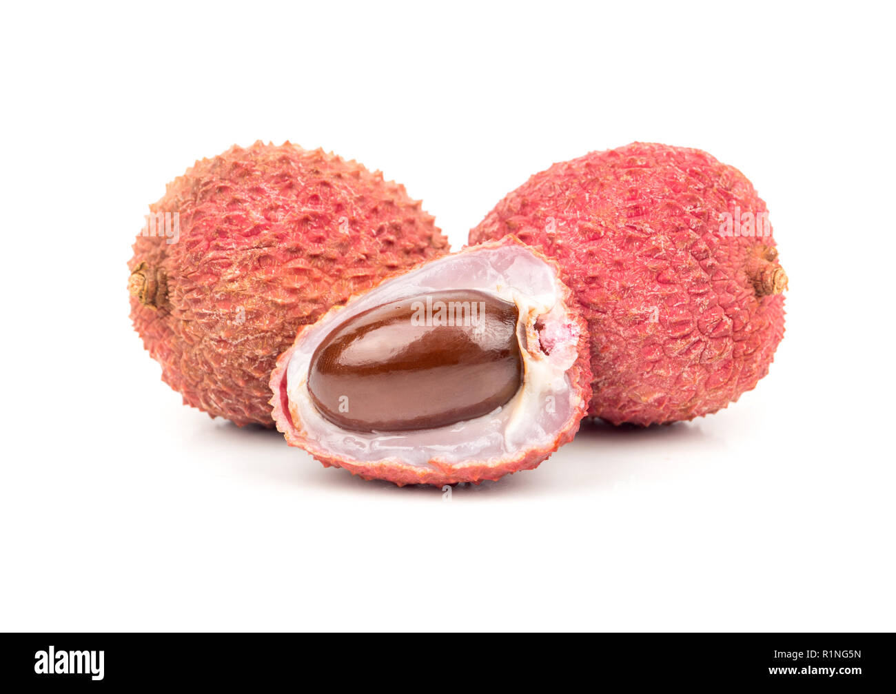 Two lychee fruit in-shell half on white background Stock Photo - Alamy