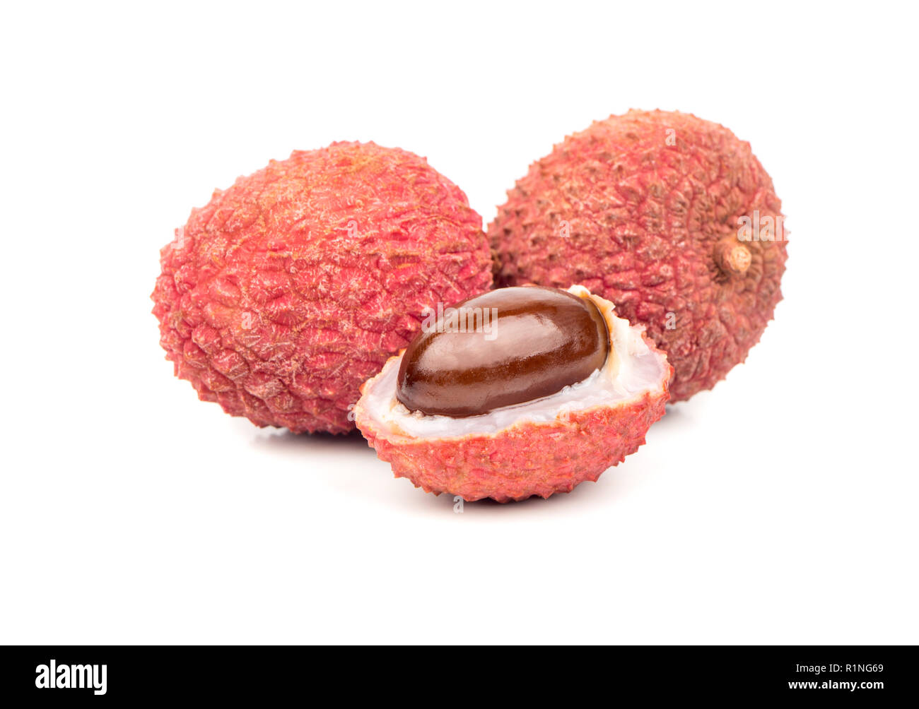 Two lychee fruit in-shell half on white background Stock Photo - Alamy